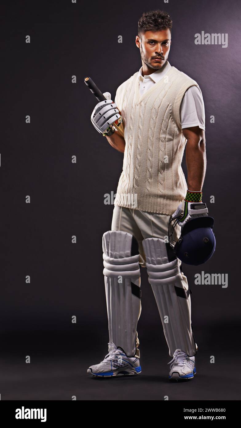 Man, portrait and cricket player with bat in studio for professional ...