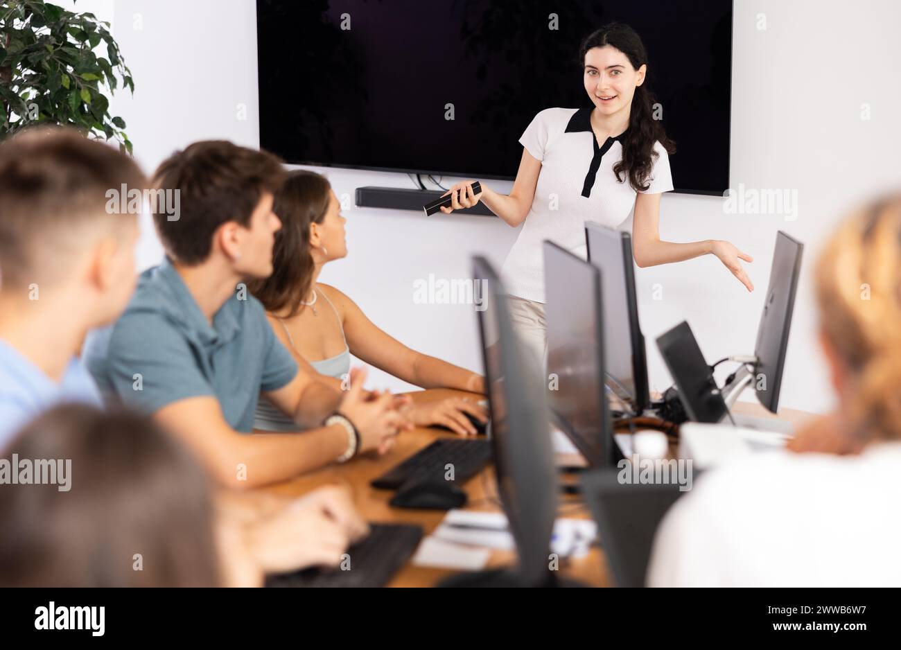 Young girl speaker stands in front of students and talks about use of ...