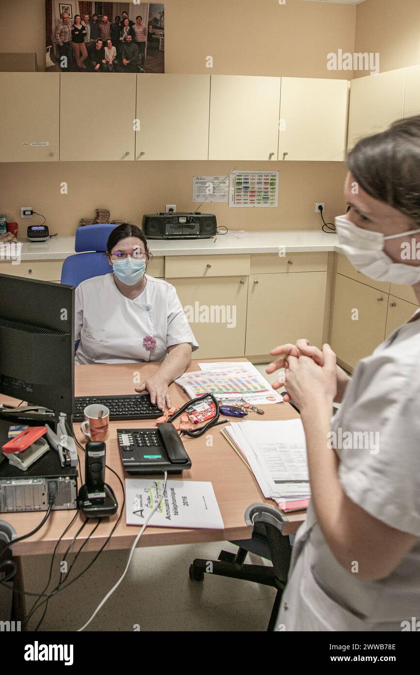 2 nurses discussing patients in the office of the maternity staff ...
