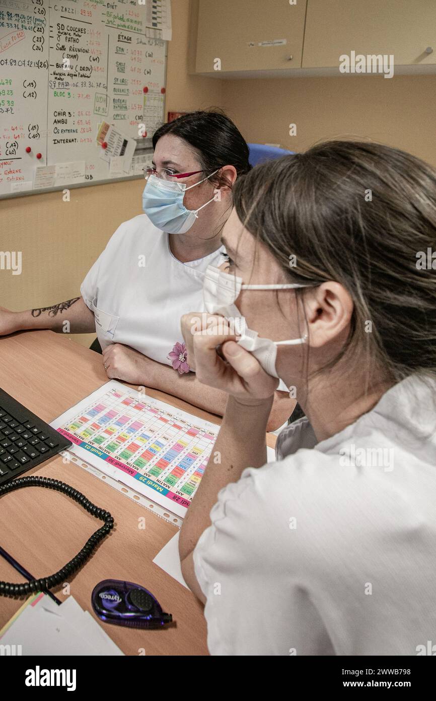 2 nurses discussing patients in the office of the maternity staff ...