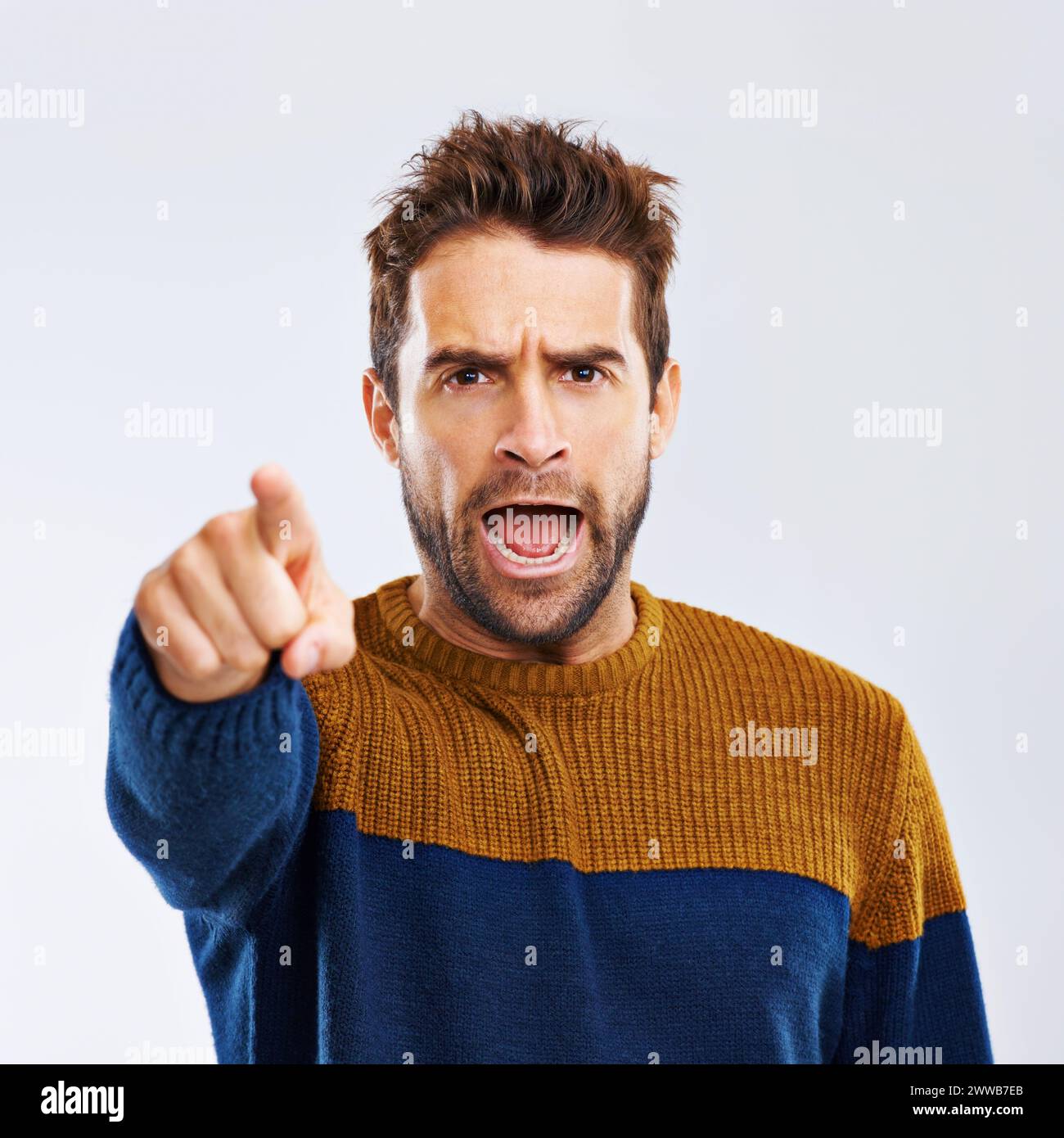 Angry man, portrait and pointing to you with scream for choice, pick or ...