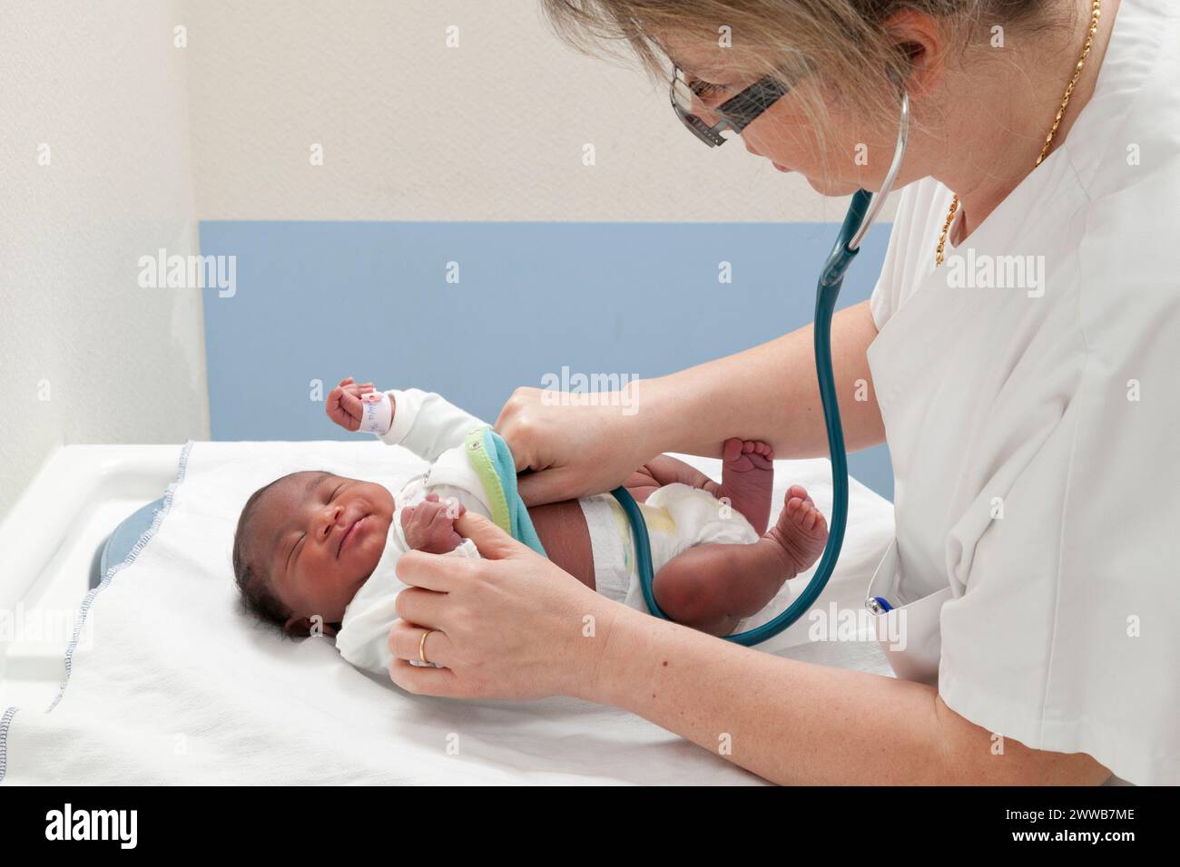 The pediatrician checks the newborn's heart rate Stock Photo - Alamy