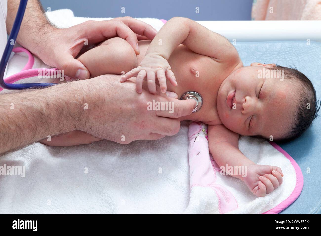 The pediatrician checks the newborn's heart rate Stock Photo - Alamy