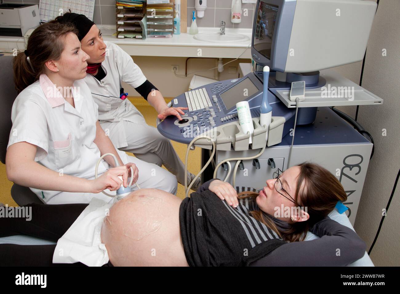 4th year student midwife performing a prenatal ultrasound under the ...