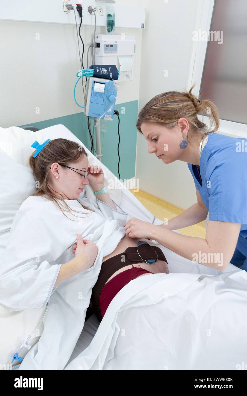 The parturient is placed in the pre-labor room. The midwife places the ...
