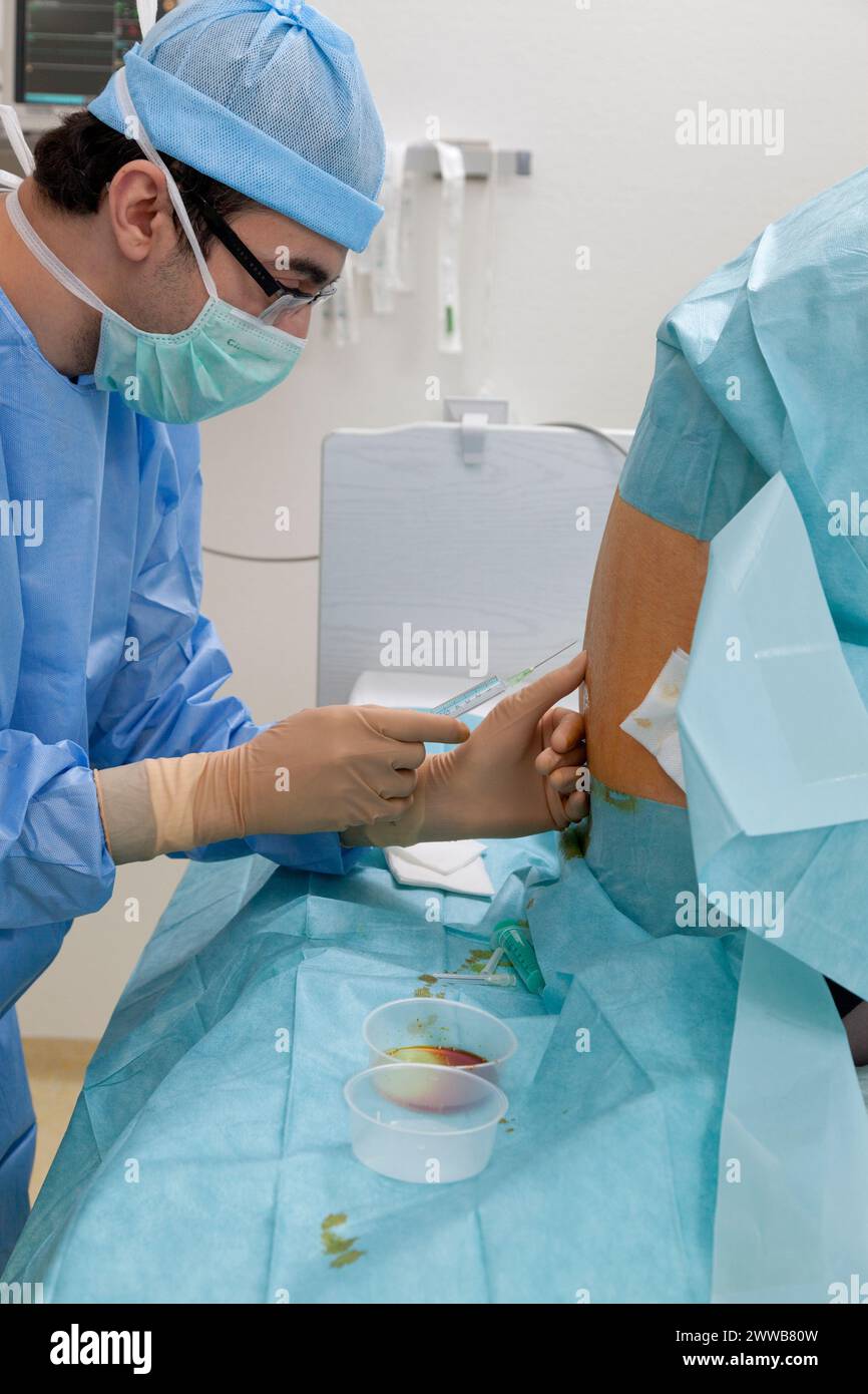 Epidural. Anesthesiologist looking for the area where he will install ...