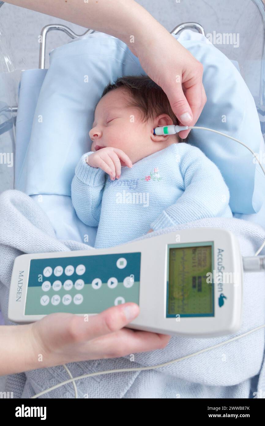 Hospital. Maternity. Hearing test - A childcare nurse performs a ...