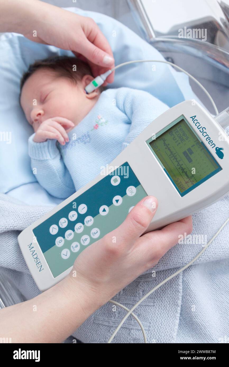 Hospital. Maternity. Hearing test - A childcare nurse performs a ...