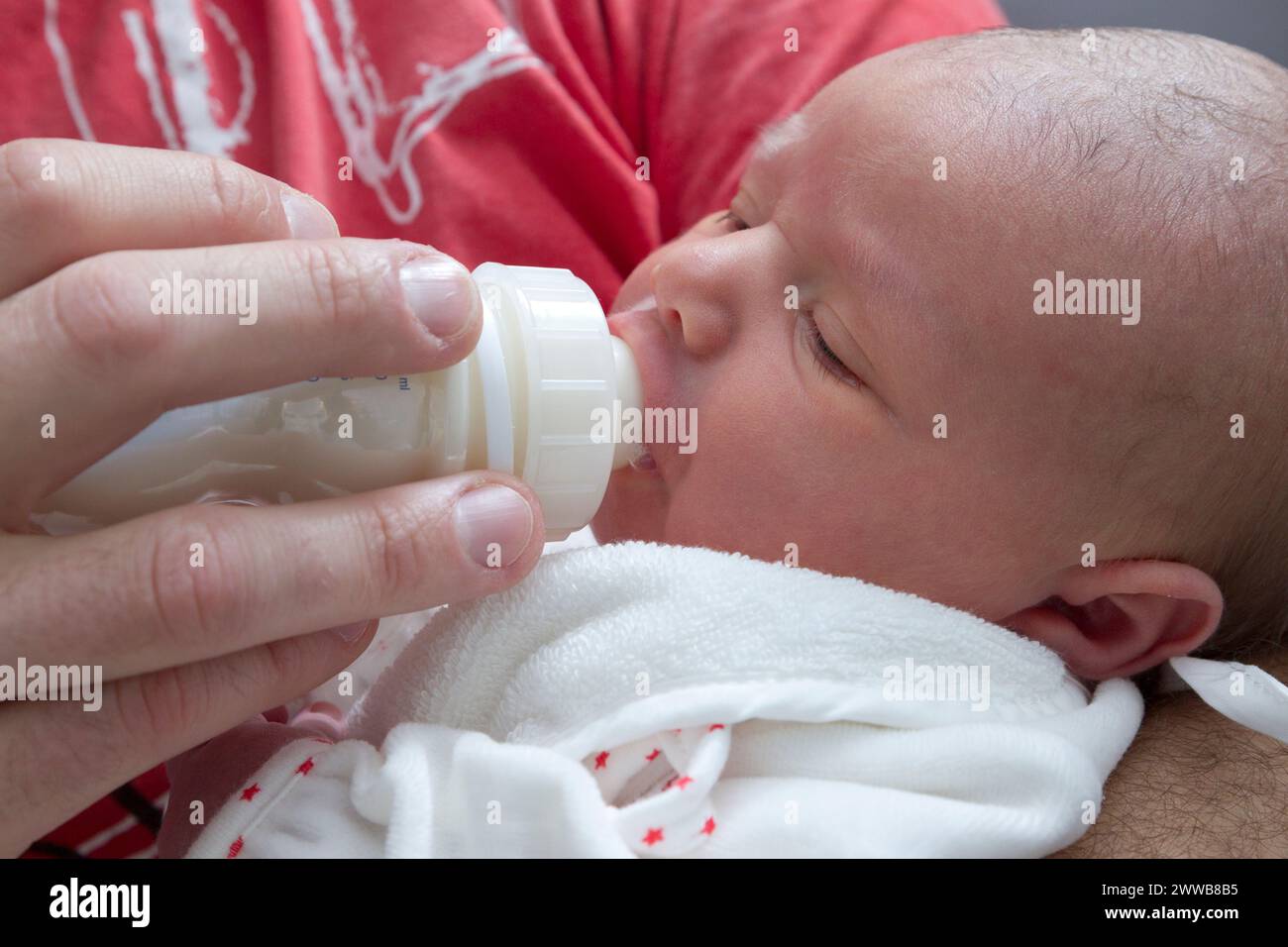 Father giving the bottle to his child at the maternity ward Stock Photo ...