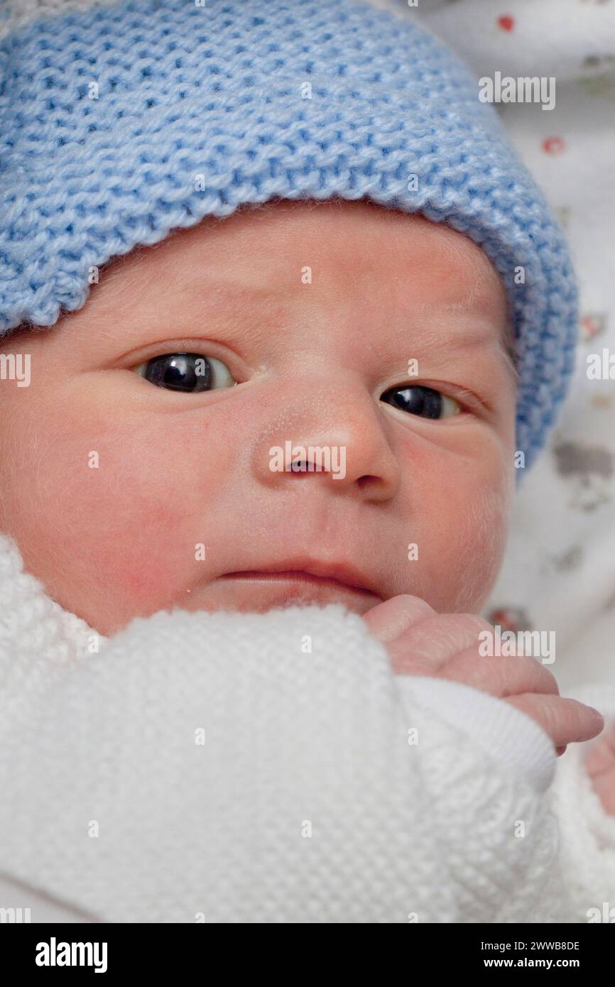 Newborn face (5 days old) awake with bonnet Stock Photo - Alamy