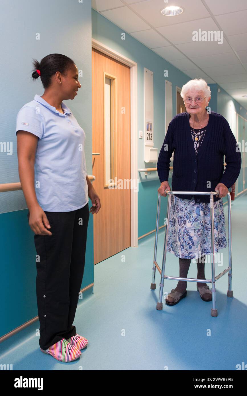 EHPAD - Caregiver encouraging a resident to move around alone with the ...