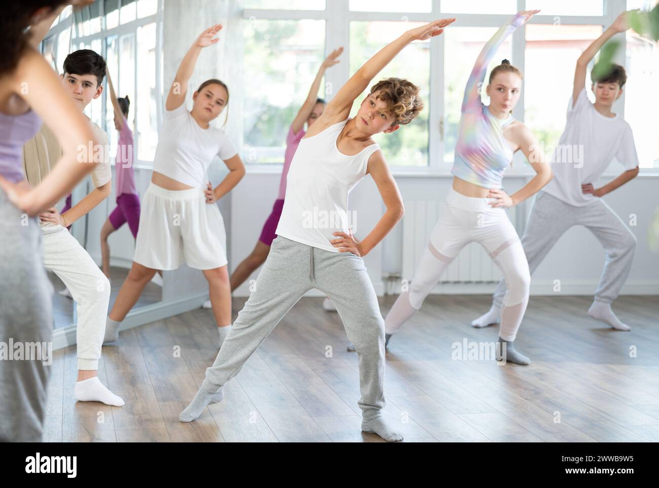 Male boy student repeats movements of unrecognizable teacher during ...