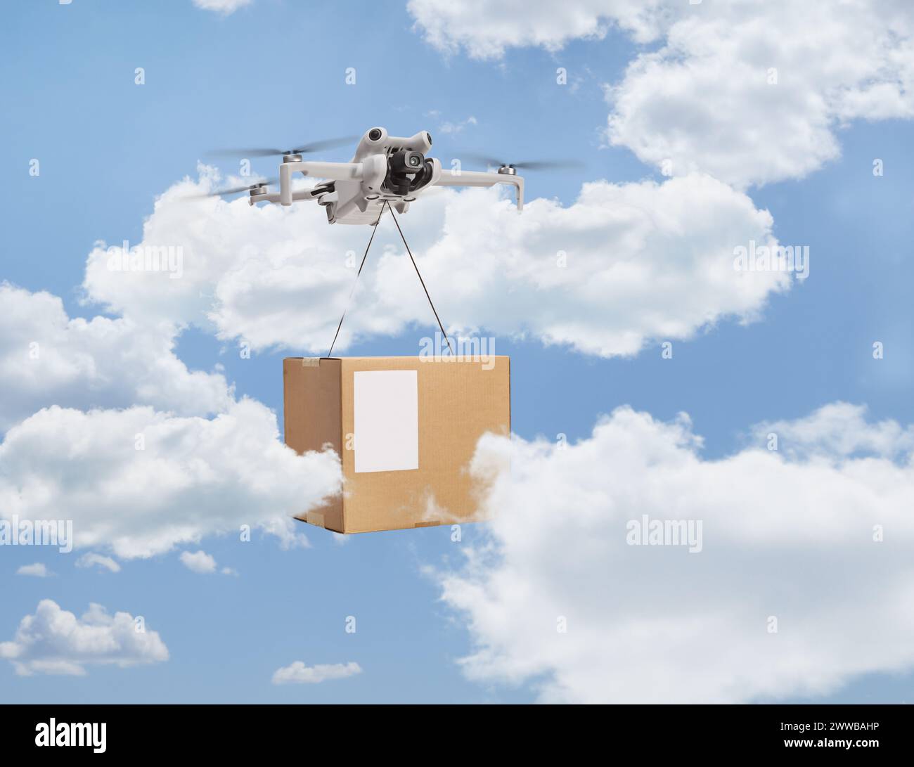 Drone delivering a cardboard box and flying in the sky Stock Photo - Alamy