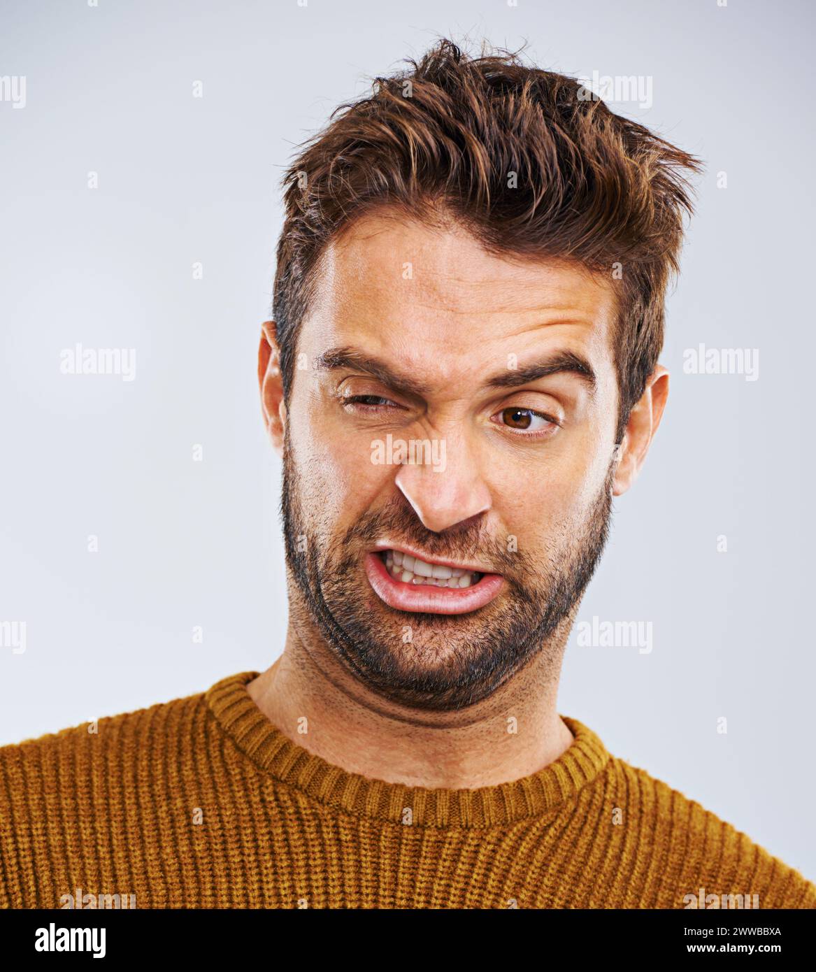 Man, face and grimace with disgust in studio for dirty hygiene ...