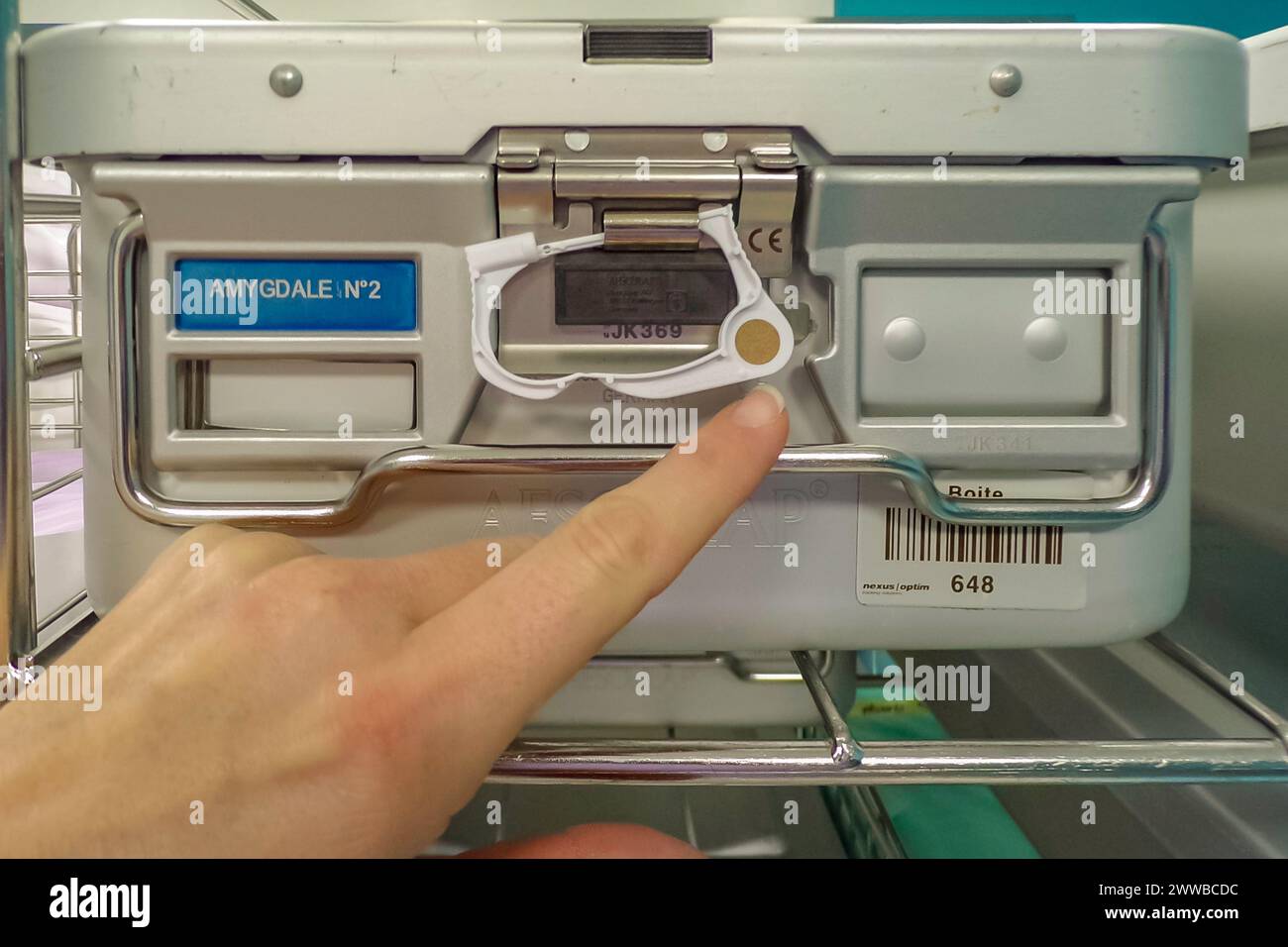 Operator pointing to the tablet certifying sterilization of tonsil ...