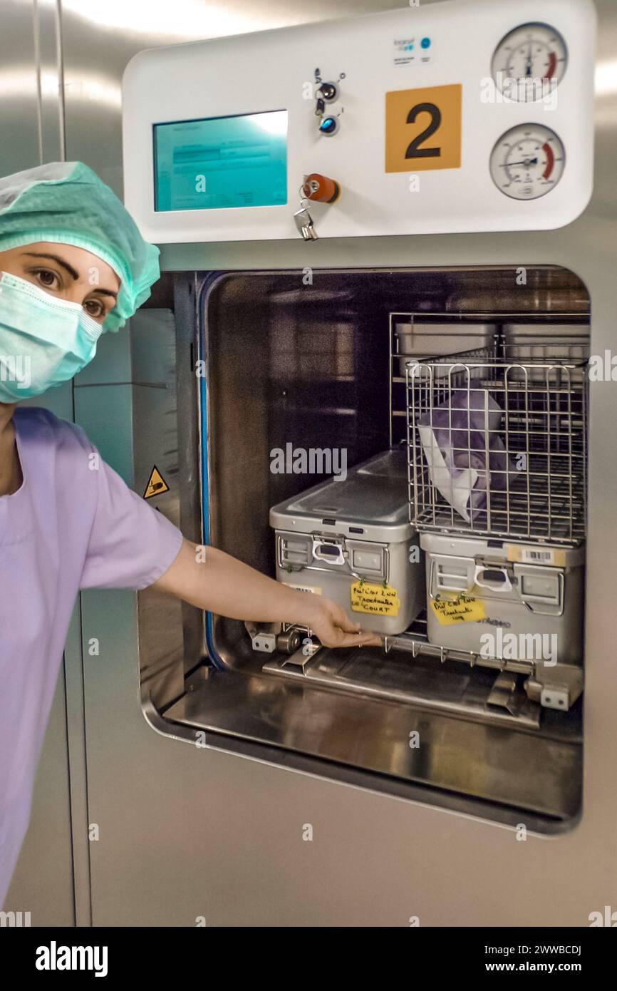Operator with ancillary cart in front of the autoclave sterilizer Stock ...