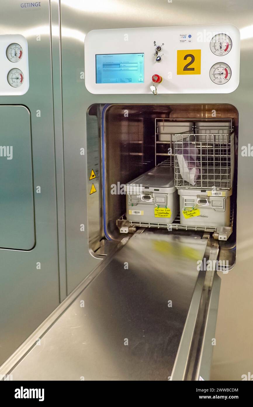 Operator with ancillary cart in front of the autoclave sterilizer Stock ...