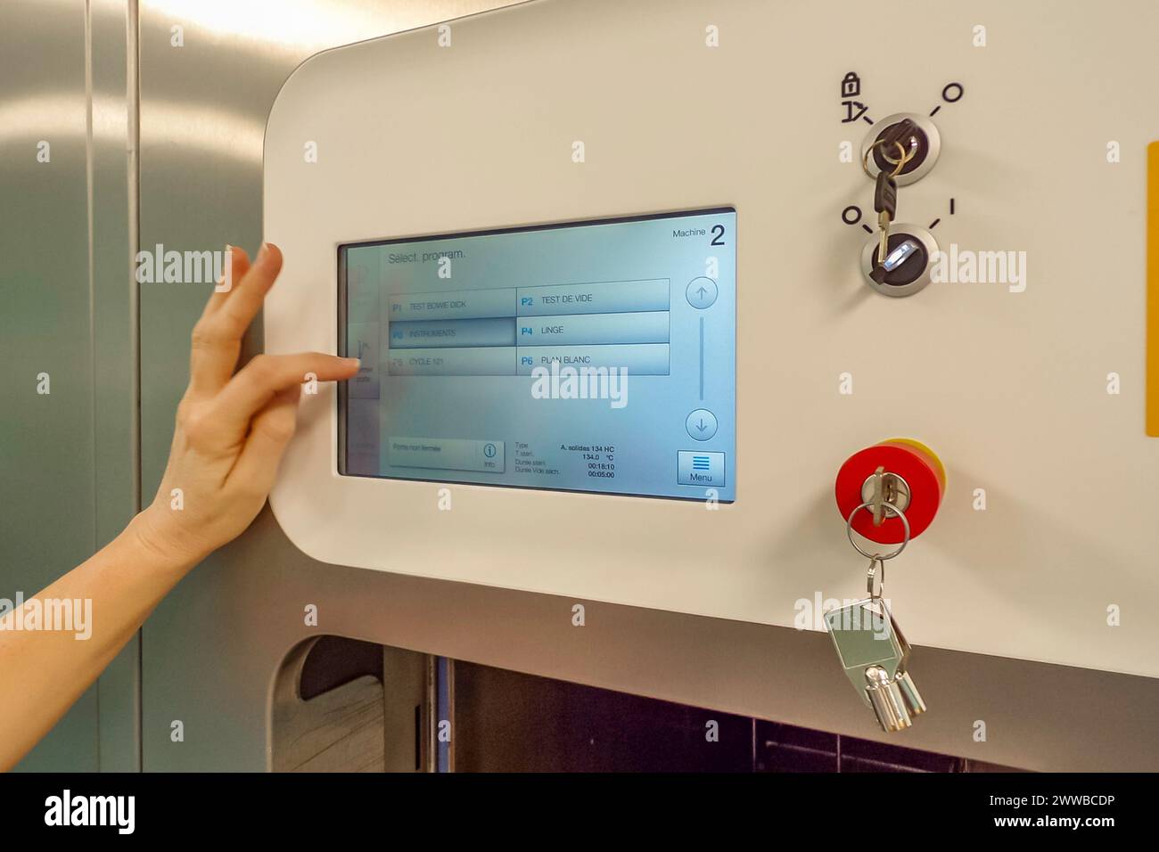 Operator adjusting the autoclave sterilizer on a digital panel Stock ...
