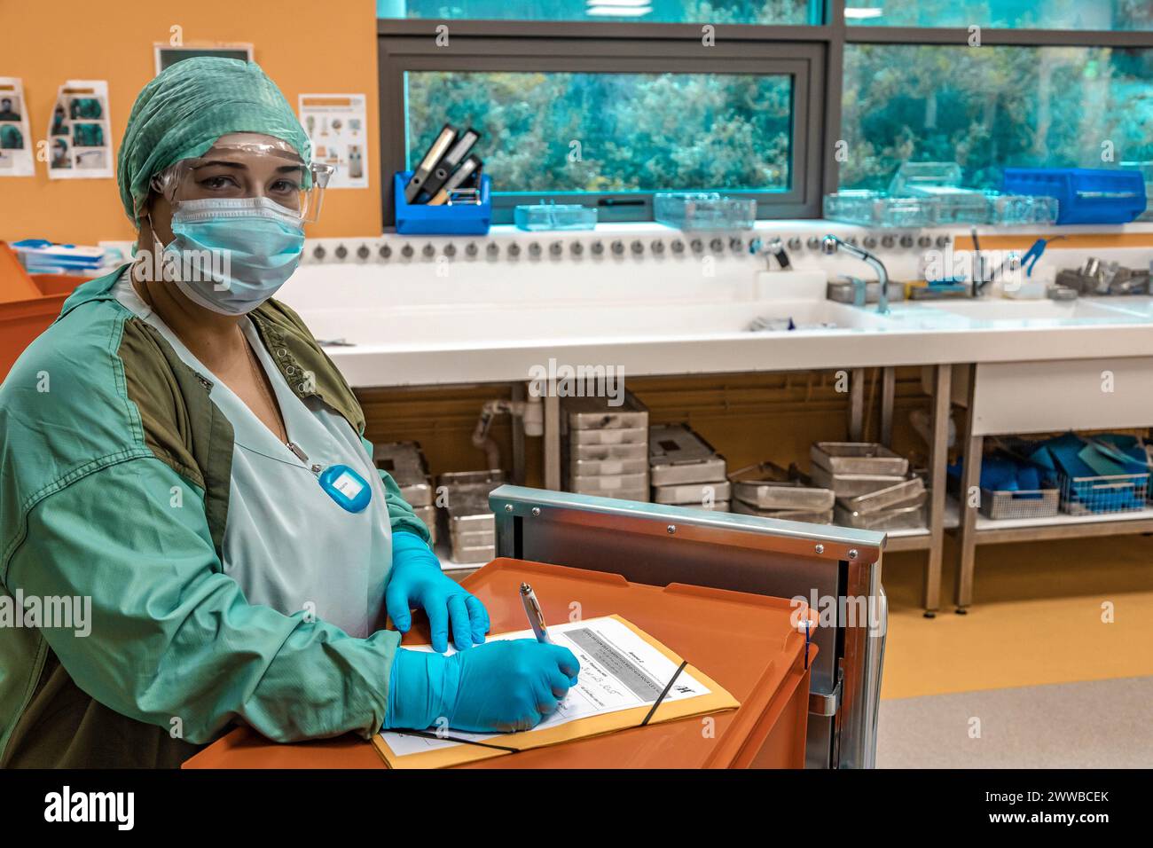 Technician filling out a deposit form Stock Photo - Alamy