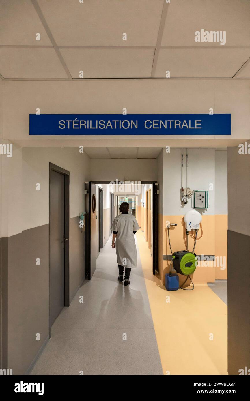 Operator walking down the central sterilization corridor from behind ...