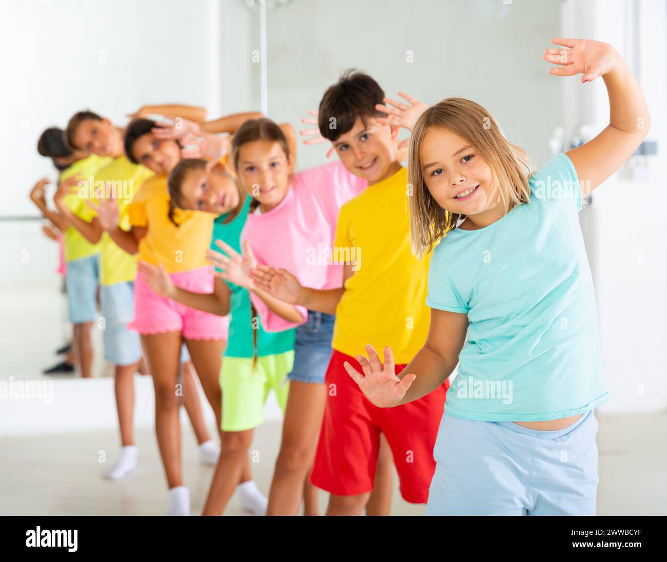 Group of children rehearsing movements of ballet in classroom Stock ...