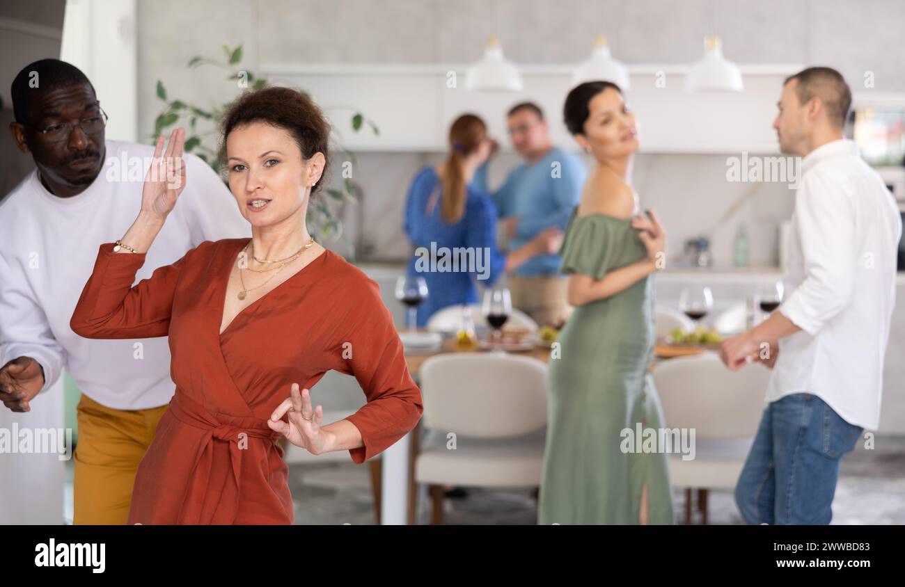 Cheerful woman enjoying active dancing at friendly home gathering Stock ...