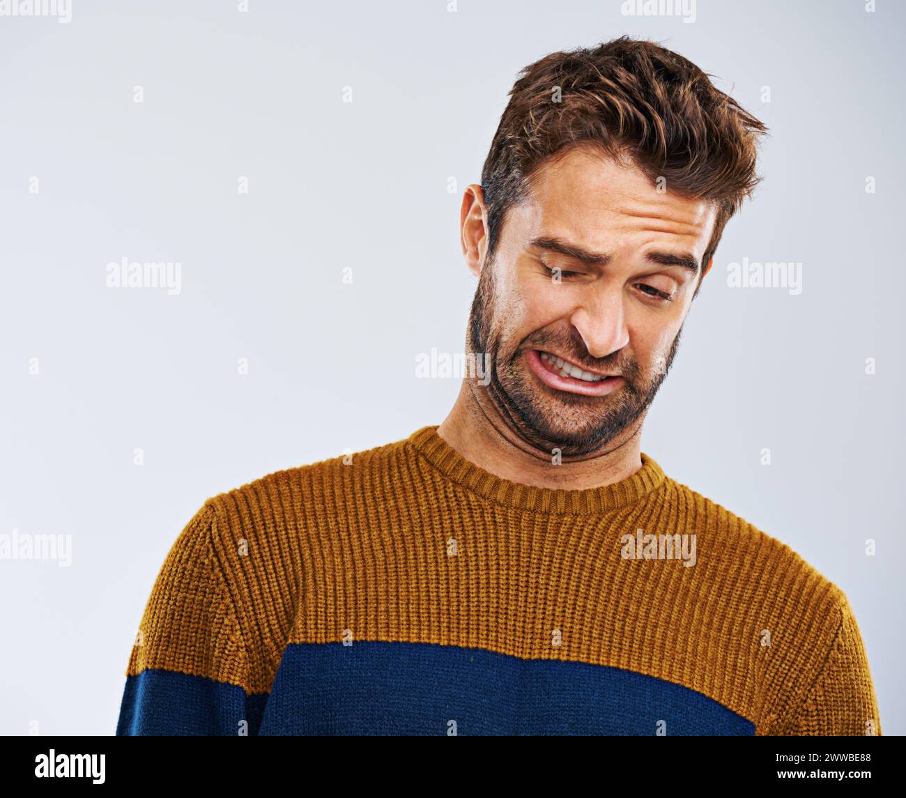 Man, frown and facial expression in studio for disgust and regret for ...