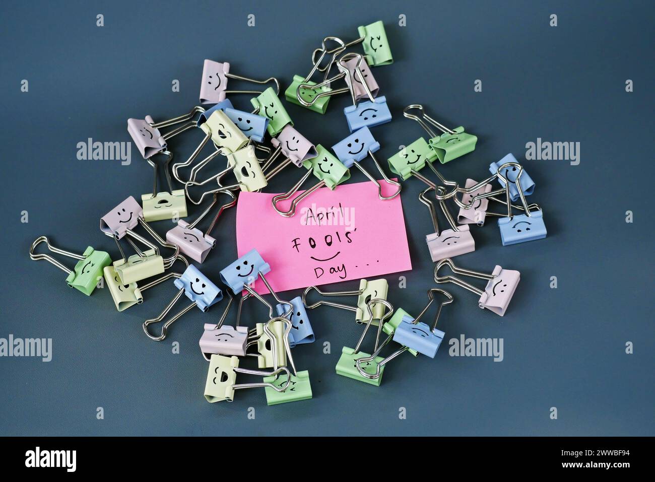 April Fools Day text on a pink stick note with funny paper clips Stock ...