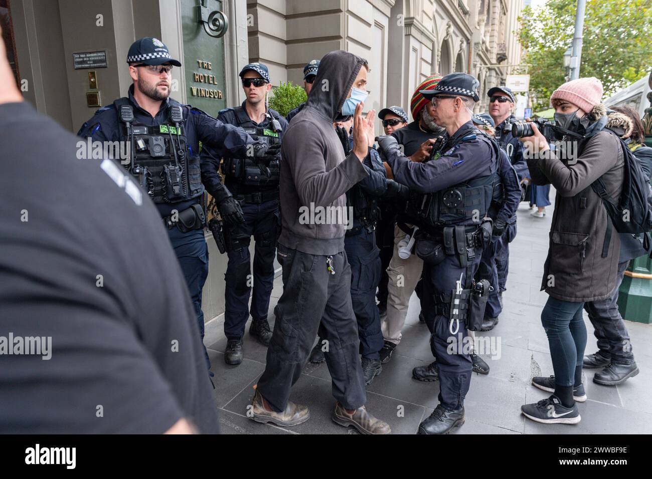 Riot police tells a left wing protester to move on during an anti-trans ...