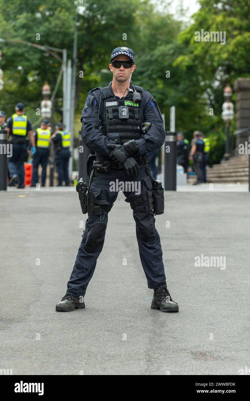 Melbourne, Australia. 23rd Mar, 2024. A riot cop tries to look menacing ...