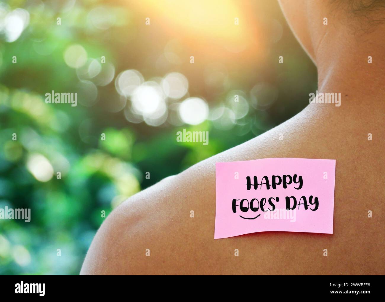 Note with text Happy Fools Day stuck to man's back Stock Photo - Alamy