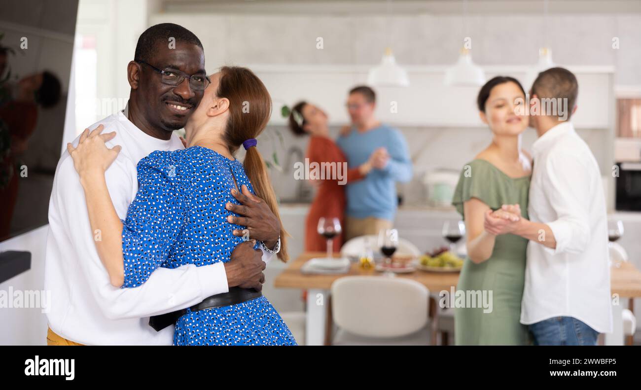 Friends party - men and women of different nationalities dancing slow ...