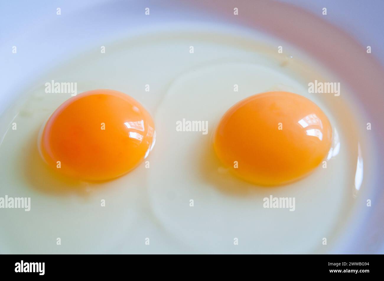Two eggs in a dish Stock Photo - Alamy