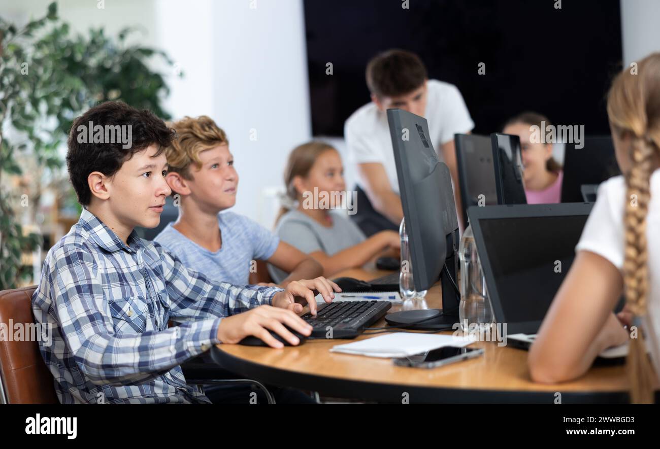 Two boys learning to work on computer in classroom Stock Photo - Alamy