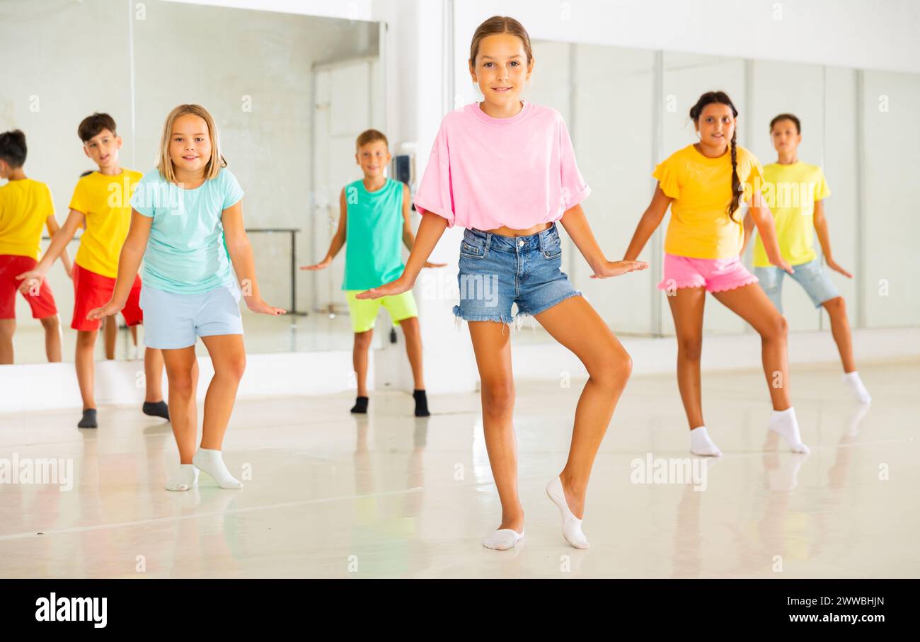 Group of kids training dance moves Stock Photo - Alamy