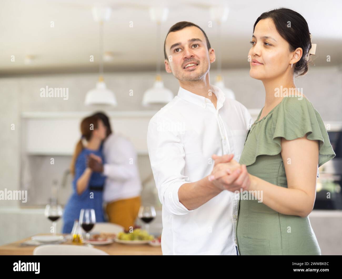Friends party - men and women of different nationalities dancing slow ...