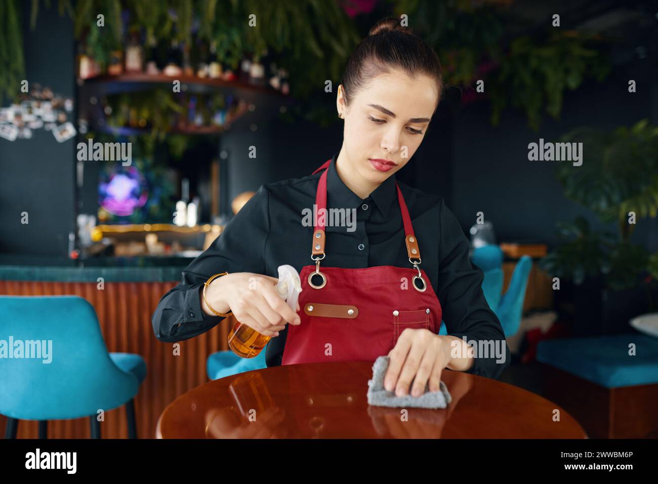 Young waiter disinfecting table hi-res stock photography and images - Alamy