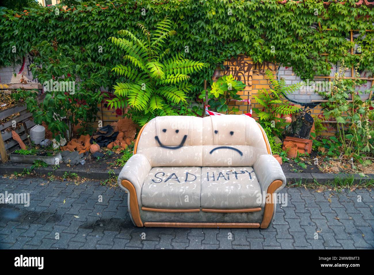 sad and happy faces on a couch Stock Photo - Alamy
