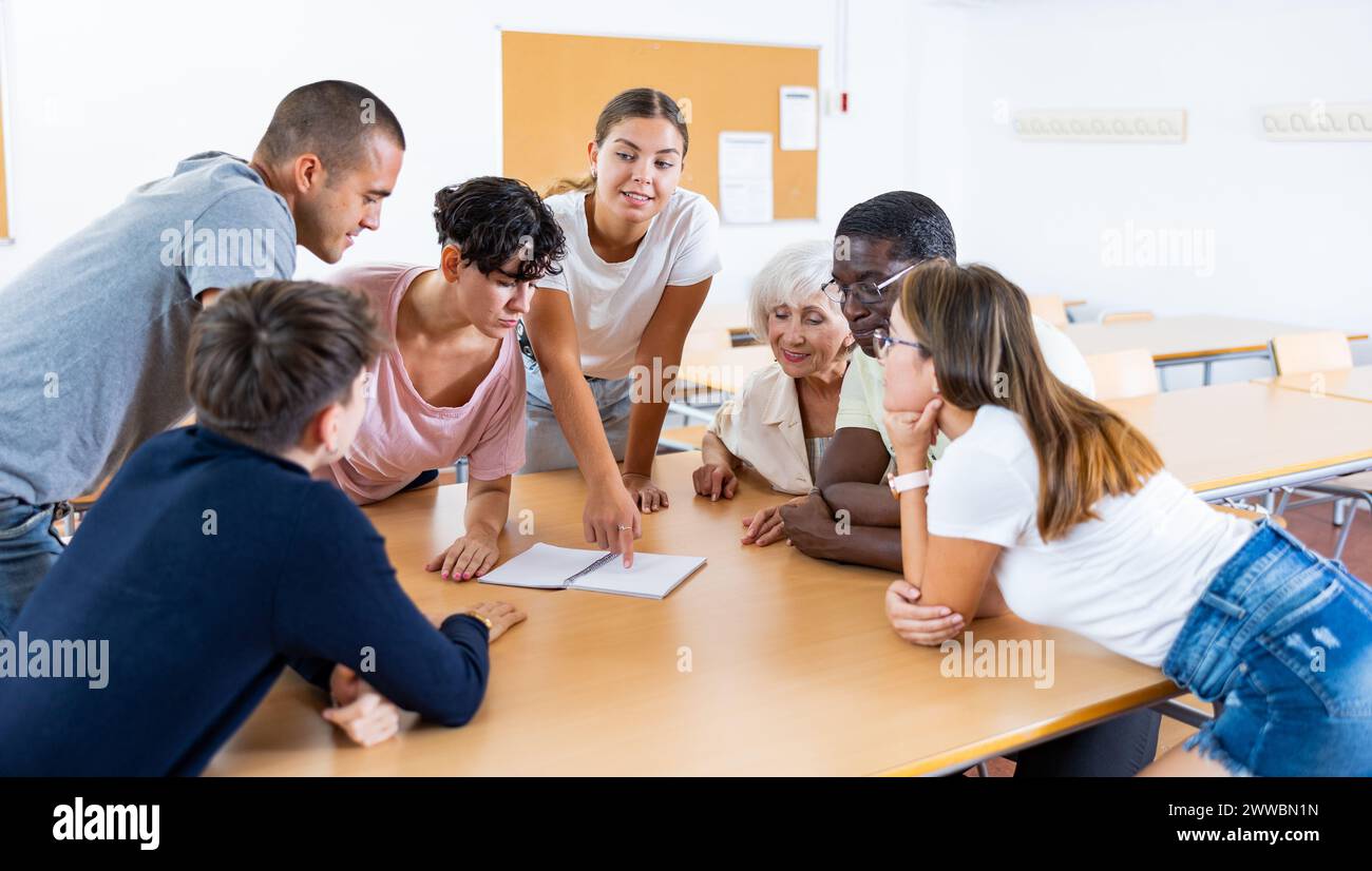 Young girl participating in Spanish language speaking club with group ...