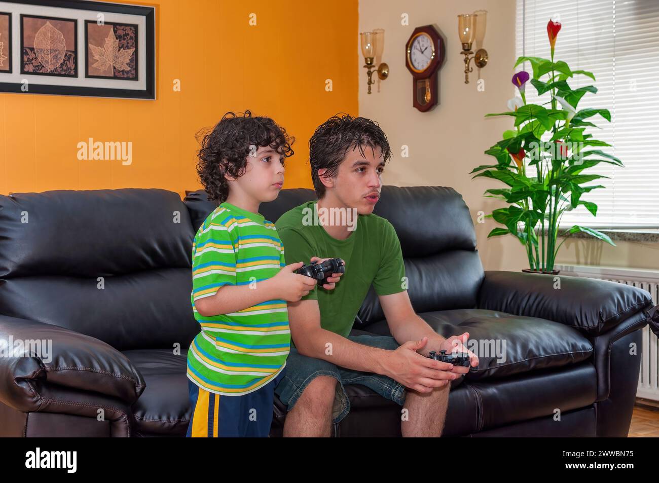 Latin American ethnicity brothers gaming in a living room, Toronto ...