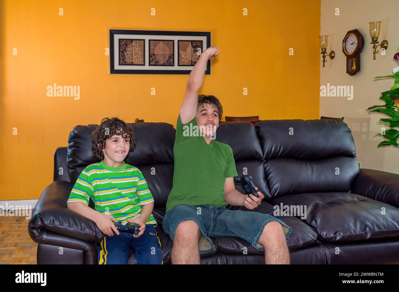 Latin American ethnicity brothers gaming in a living room, Toronto ...