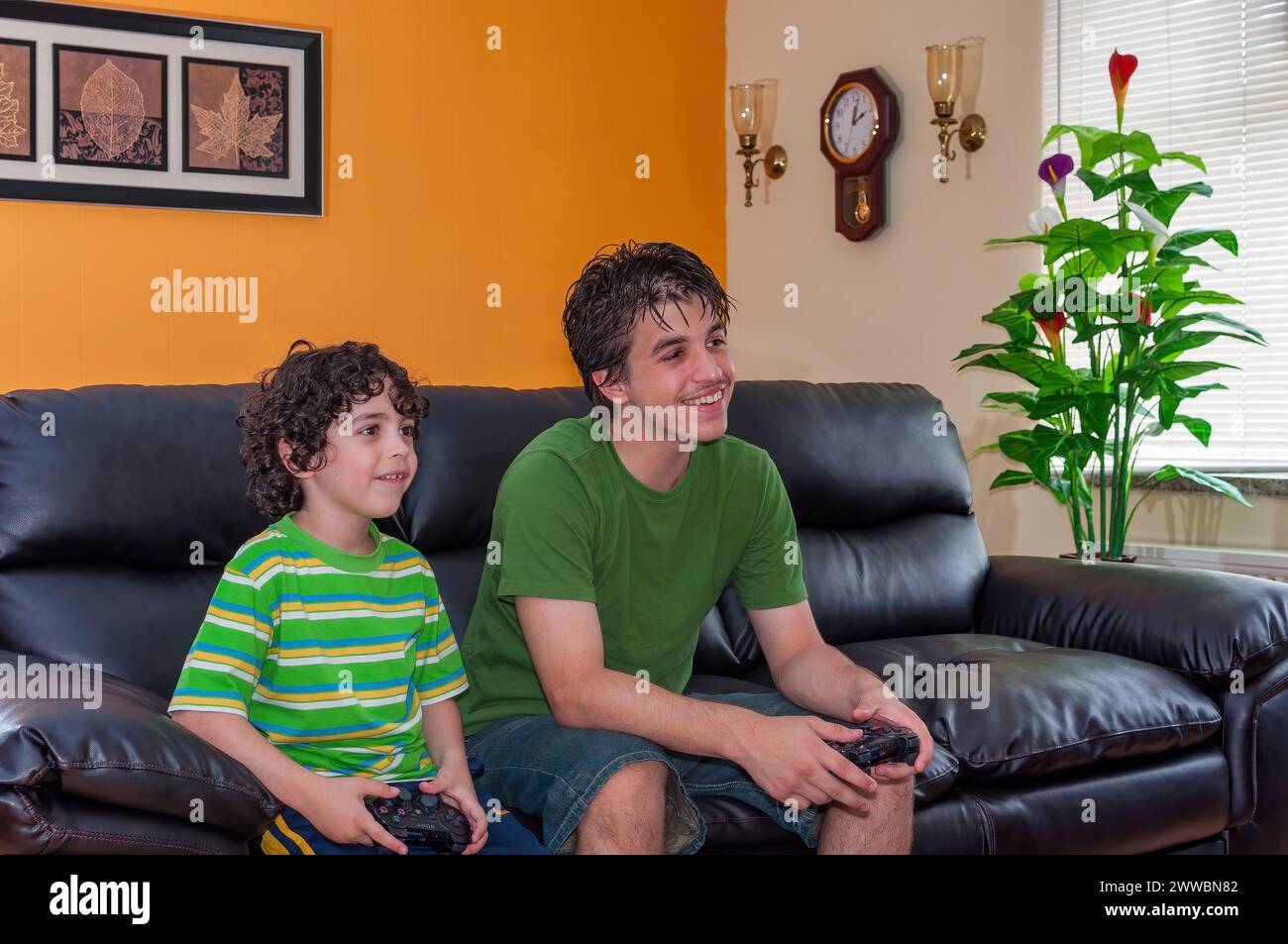 Latin American ethnicity brothers gaming in a living room, Toronto ...