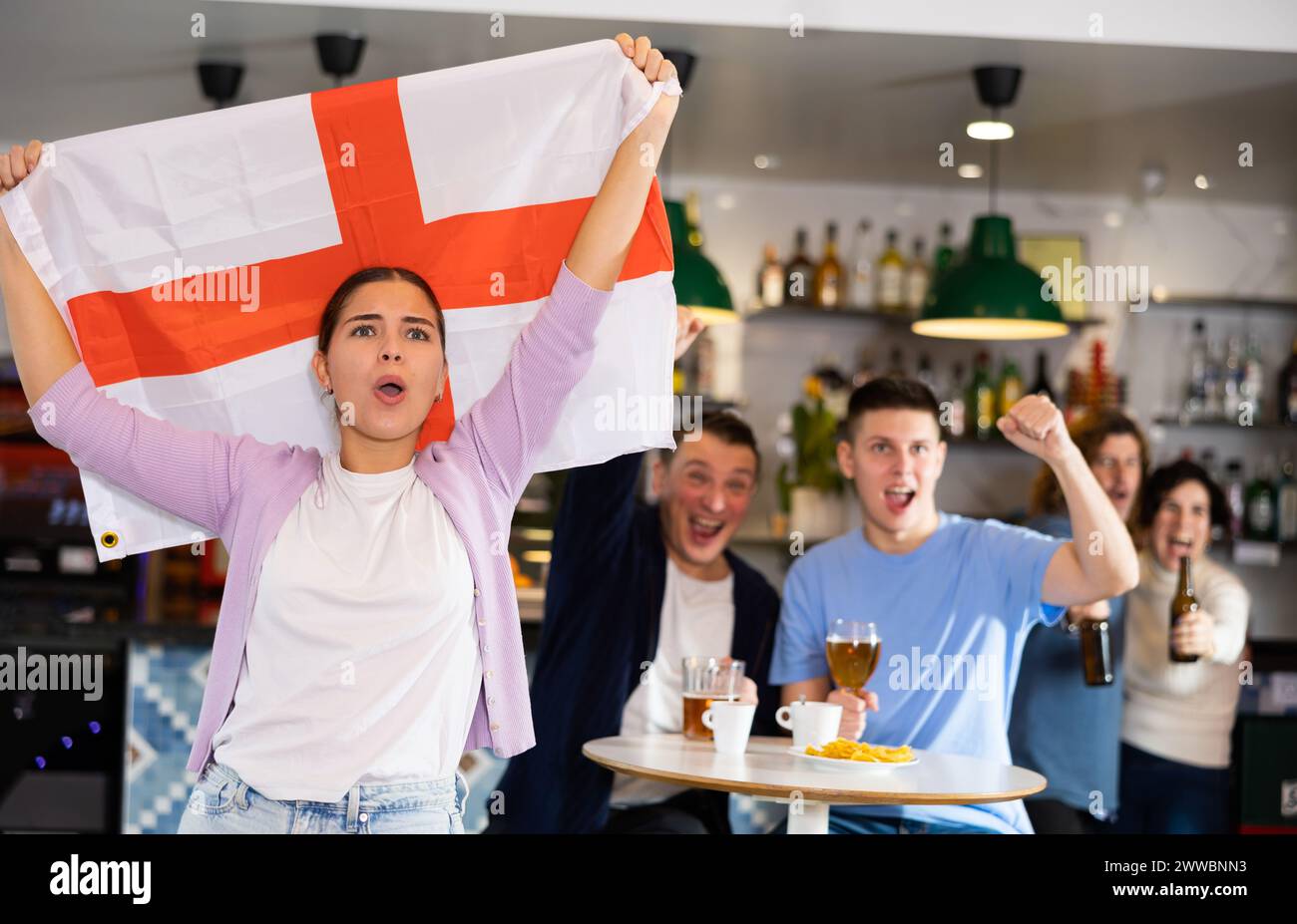 Group of people with England flag toasting with beer, having fun at ...