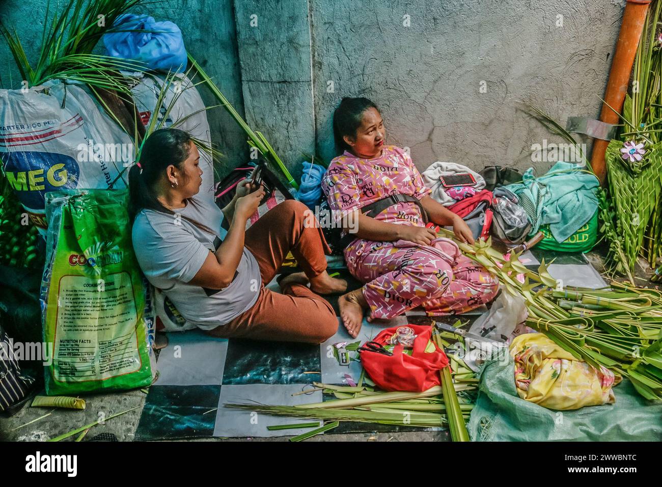 Women make palm fronds in the street in preparation for Palm Sunday in ...