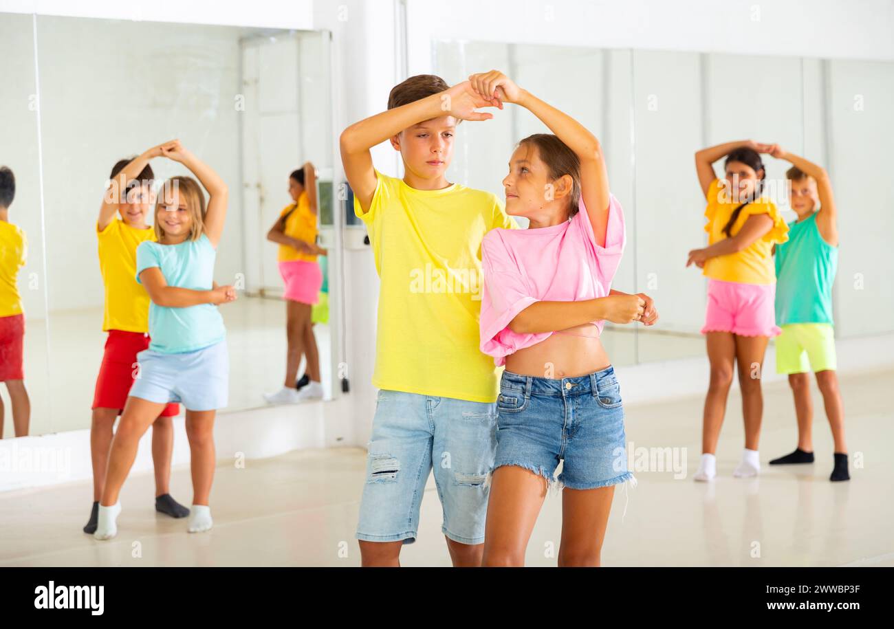 Kids in pairs exercising salsa moves Stock Photo - Alamy