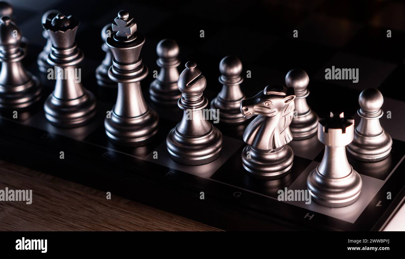 Angled view of chess pieces on board. Siver chessmen Stock Photo - Alamy