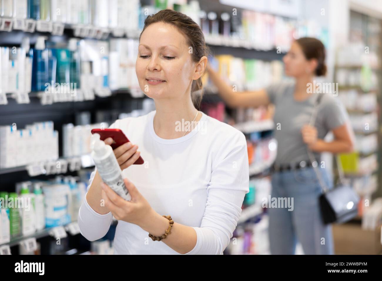 In pharmacy visitor scan QR Code and reads composition of cream for ...