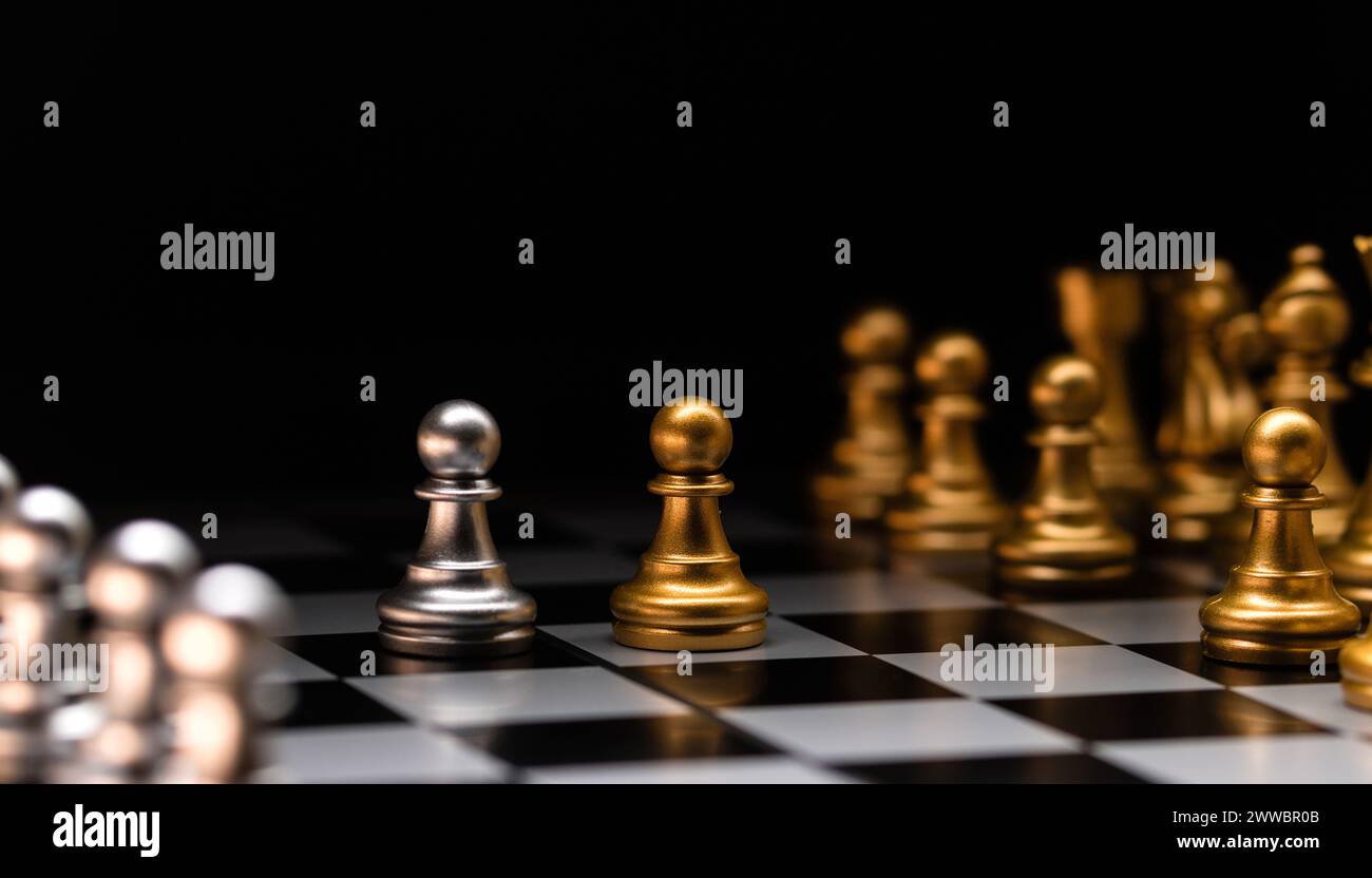 Focused pawn. Silver chess pieces and golden rivals. Chessmen on a ...