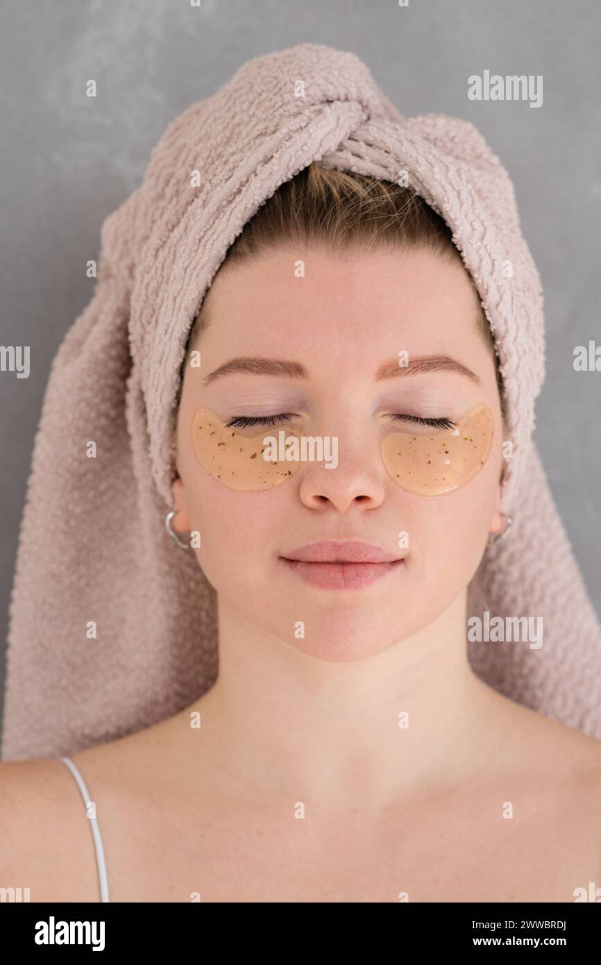 Applying eye patches in skincare routine. Woman wear organic patch ...