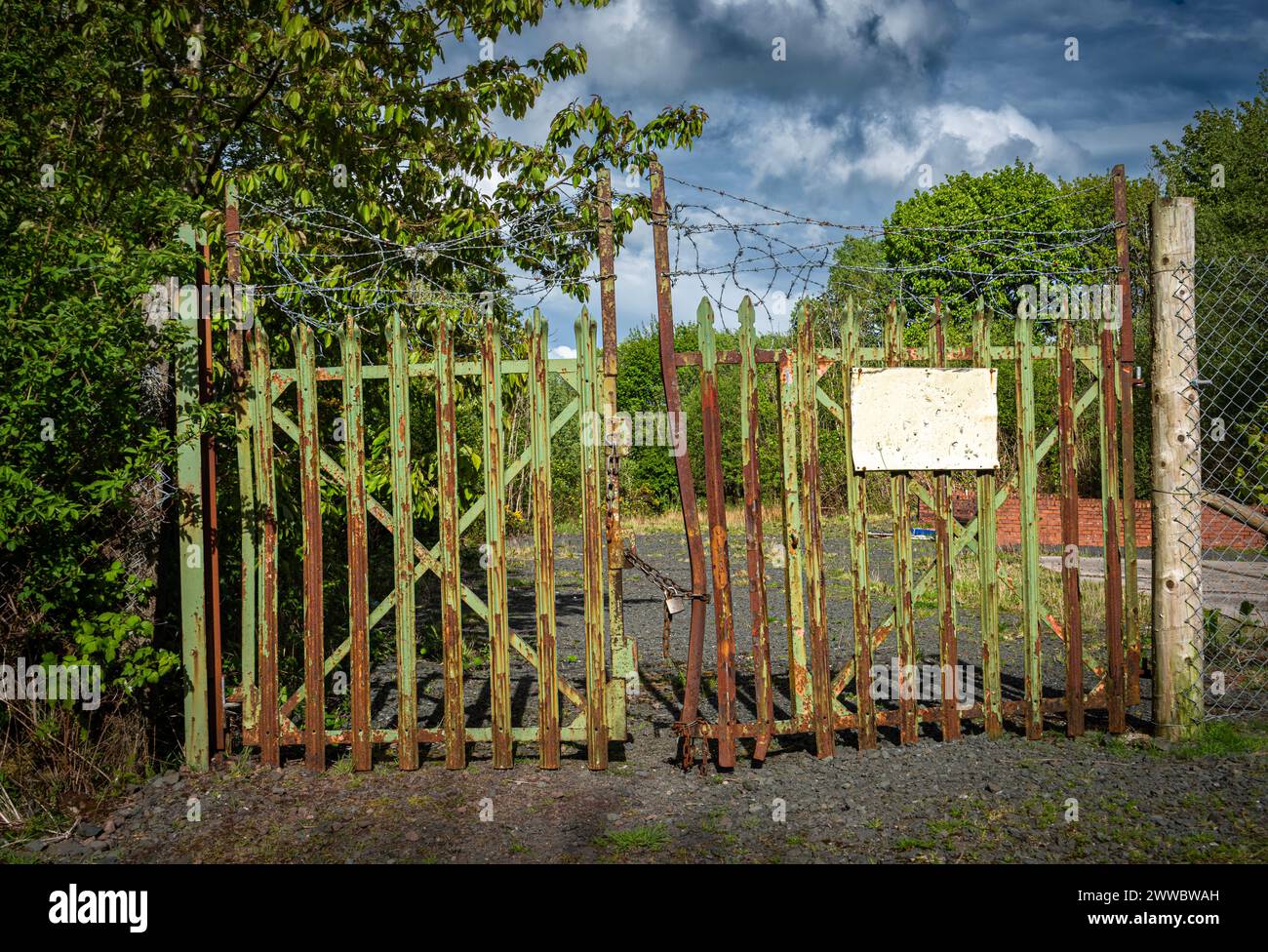 Rusted Gates partially ajar but chained together with a padlock to ...